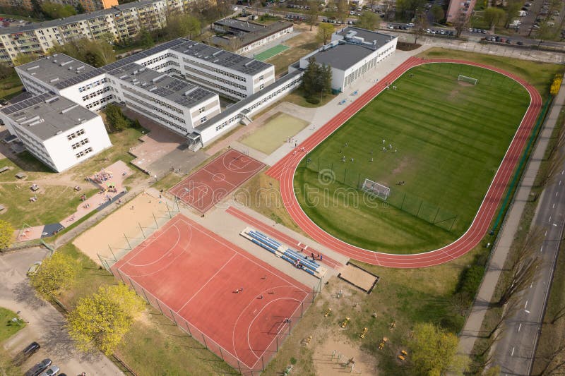 School Complex with Sports Fields and Urban Landscape - Aerial View ...