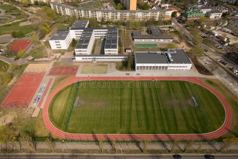School Complex with Sports Fields and Urban Landscape - Aerial View ...