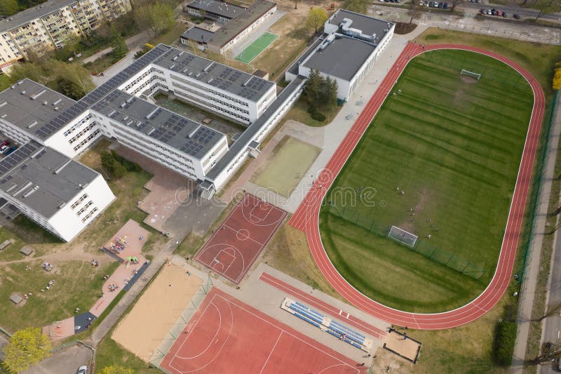 School Complex with Sports Fields and Urban Landscape - Aerial View ...