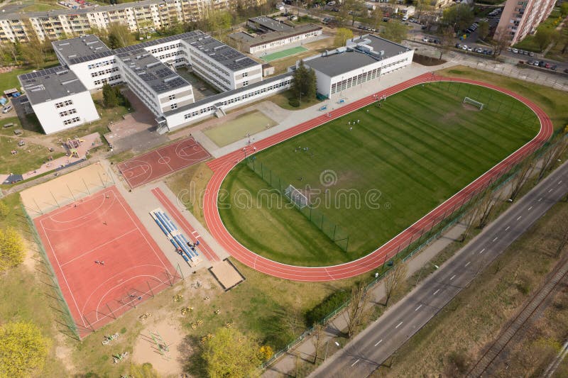 School Complex with Sports Fields and Urban Landscape - Aerial View ...