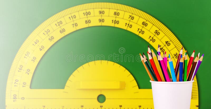 School Concept Colored Penciil and Yellow Protractor on Green ...