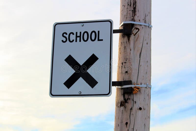School Crossing Sign on a Power Pole with Cloudy Sky Background Stock ...