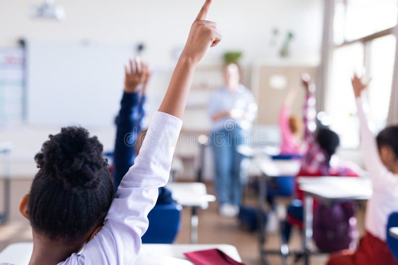 School Female Teacher Engaging Diverse Students Raising Hands Classroom ...