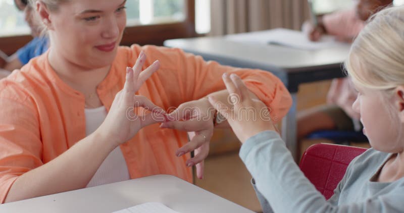 In School, Female Teacher and Student Practicing Sign Language Together ...
