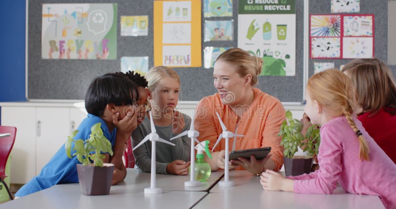 In School, Female Teacher Using Tablet Teaching Group of Children about ...