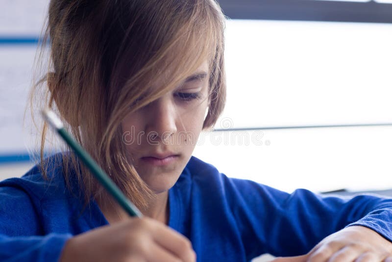 In School, Focused Boy Writing with Pencil in Classroom, Concentrating ...