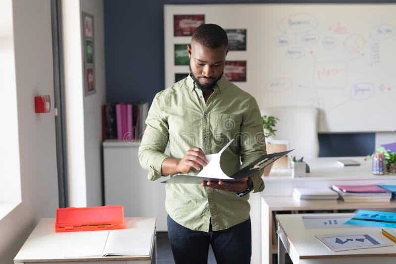 A Modern Classroom with Green Walls, Red Chairs, White Tables, and ...
