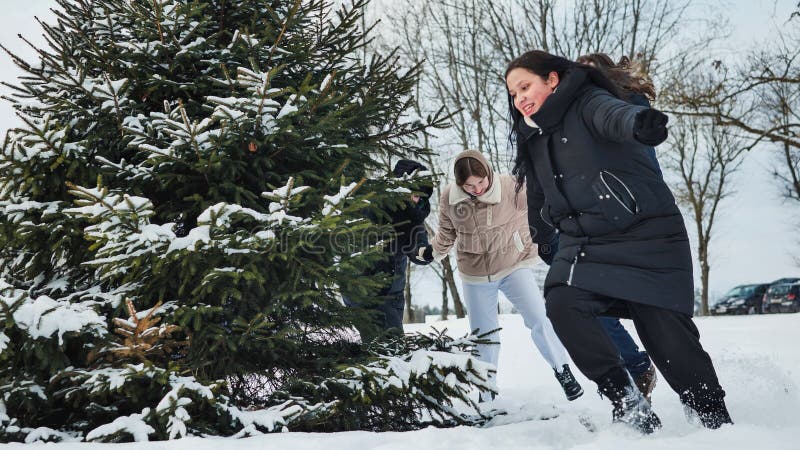 School Friends Run Around the Spruce Tree Holding Hands. Christmas ...
