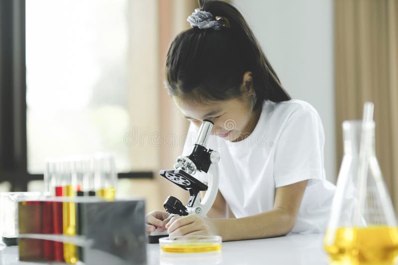 Little Child with Learning Class in School Laboratory Using Microscope ...