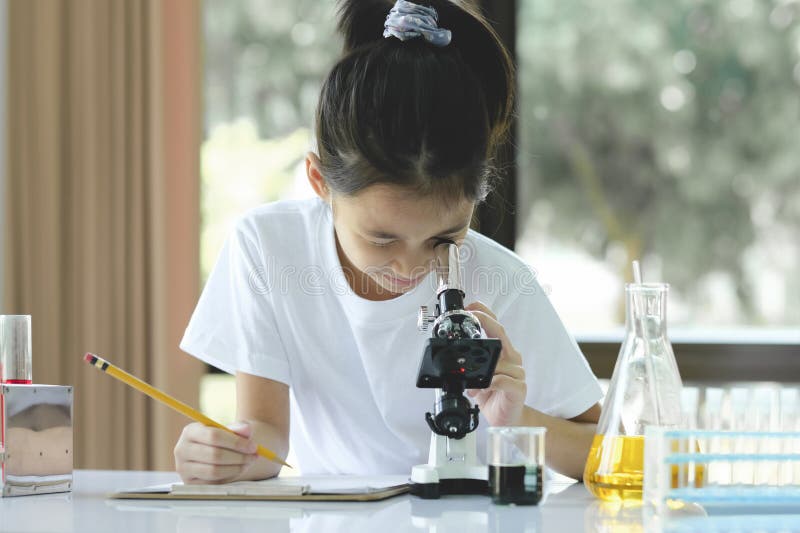 Little Child with Learning Class in School Laboratory Using Microscope ...
