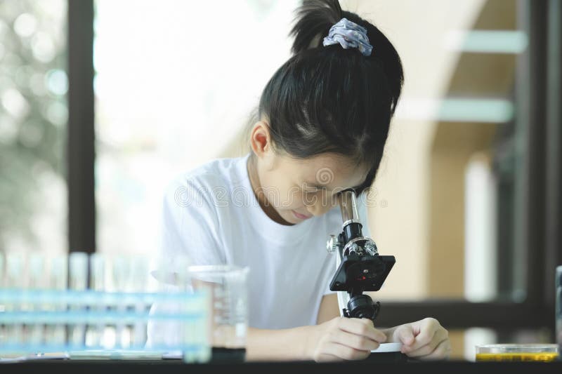 Little Child with Learning Class in School Laboratory Using Microscope ...