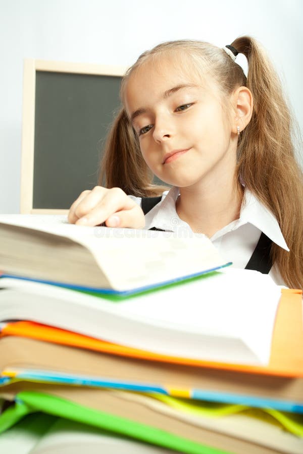 School Girl Making Homework Behind Stack Of Books. Stock Image - Image ...
