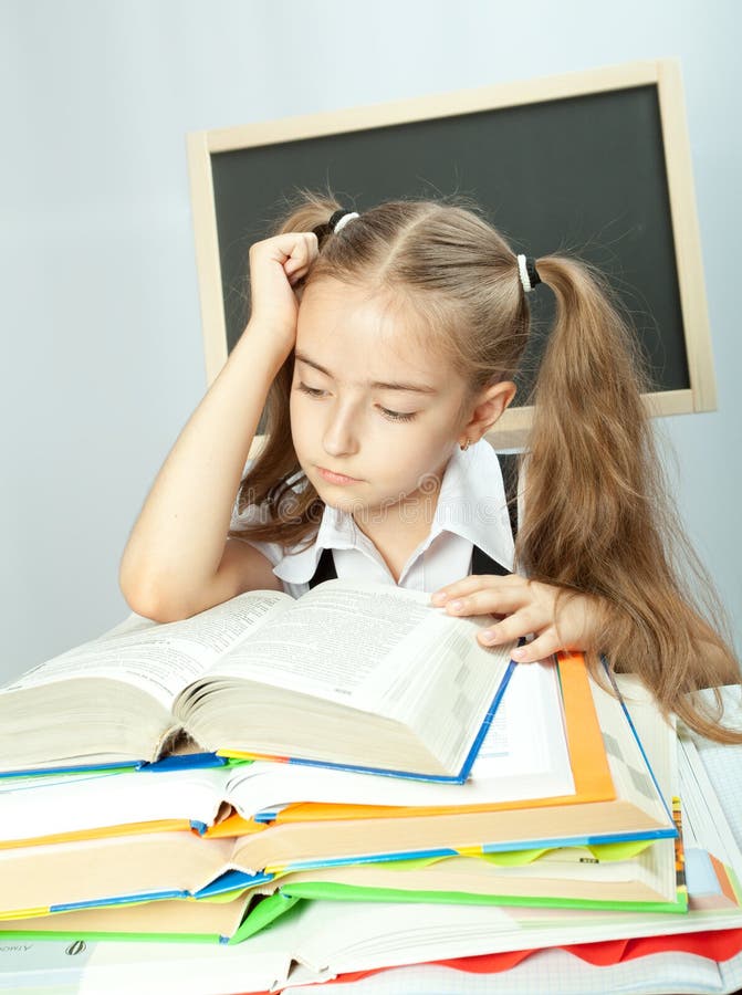 School Girl Making Homework Behind Stack of Books. Stock Image - Image ...
