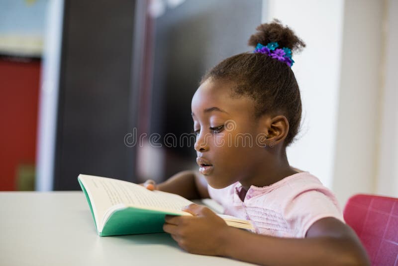 School Girl Reading Book in Classroom Stock Photo - Image of lifestyle ...