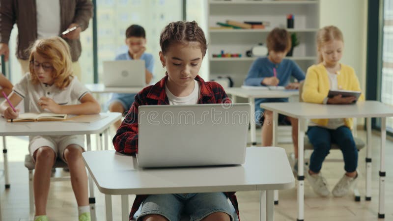Portrait Smiled Little Girl Sitting on the Desk with Laptop in a Class ...