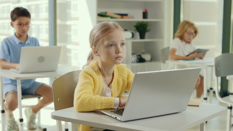 Pupils Using the Computers and Tablets Sitting in the Class during ...