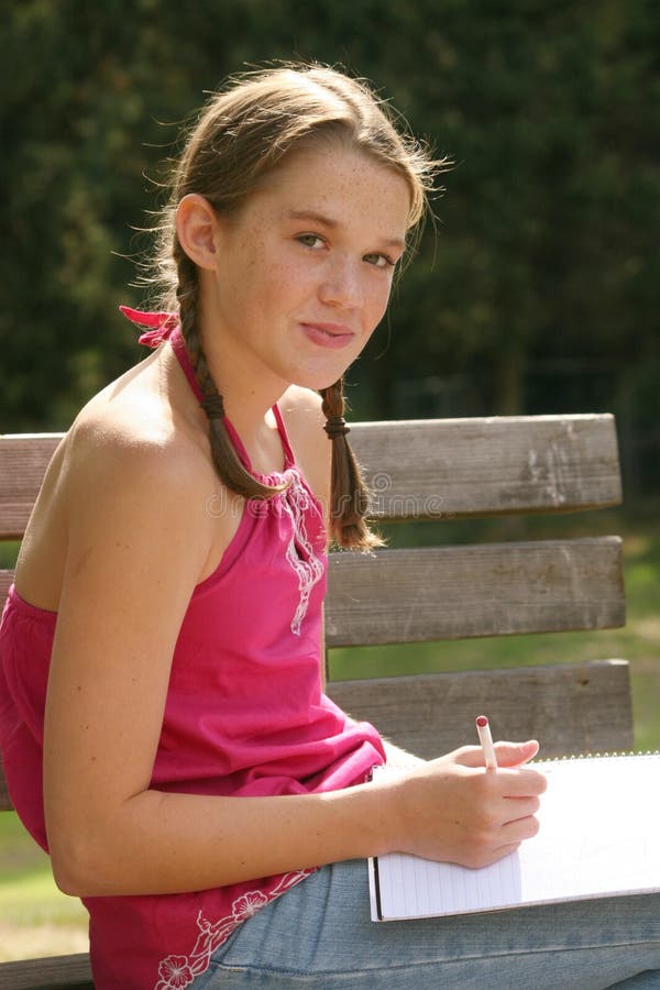School GIrl Writing in Notebook Outdoors Stock Image - Image of young ...