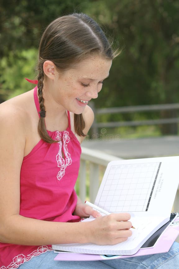 School GIrl Writing in Notebook Outdoors Stock Image - Image of ...