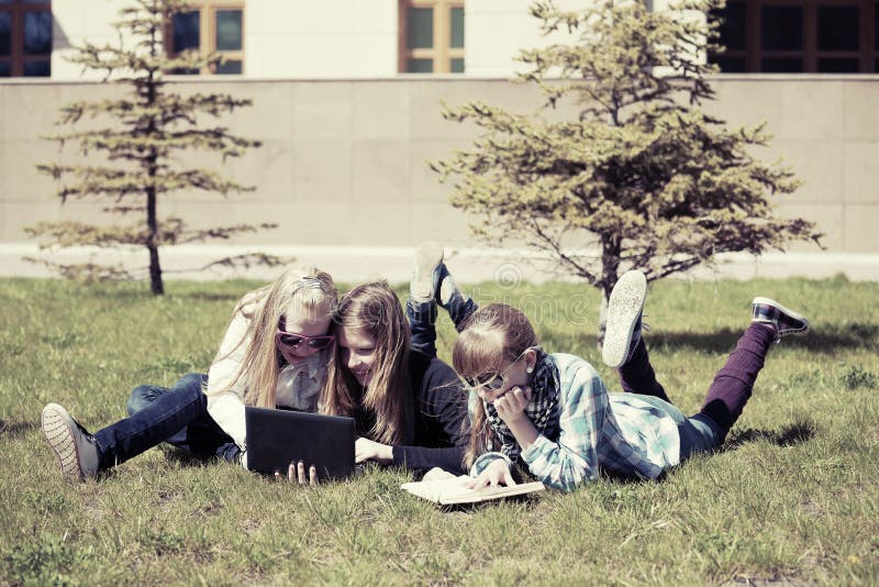 School Girls Lying on the Grass in Campus Stock Image - Image of group ...