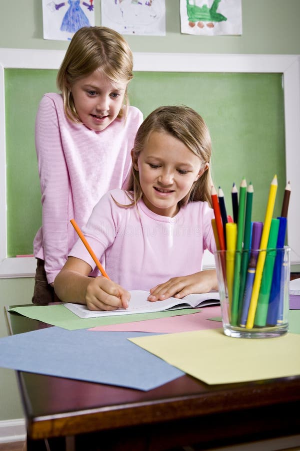 School Girls Writing in Notebook in Classroom Stock Image - Image of ...
