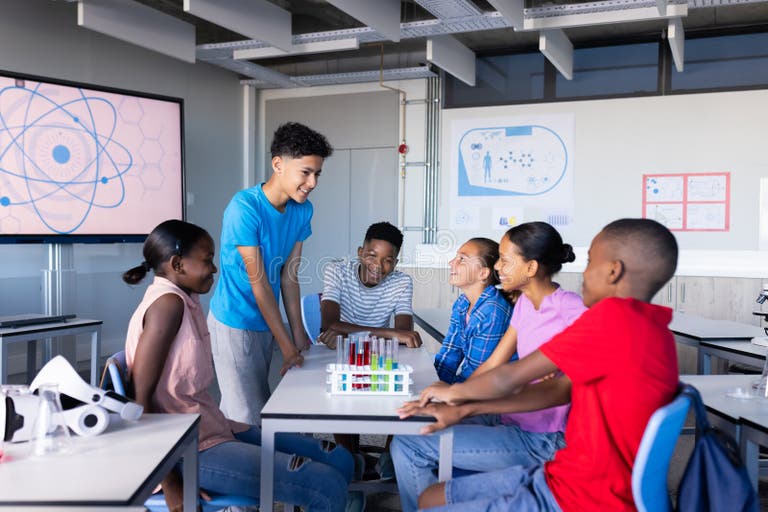 In School, Group of Students Discussing Science Project with Test Tubes ...