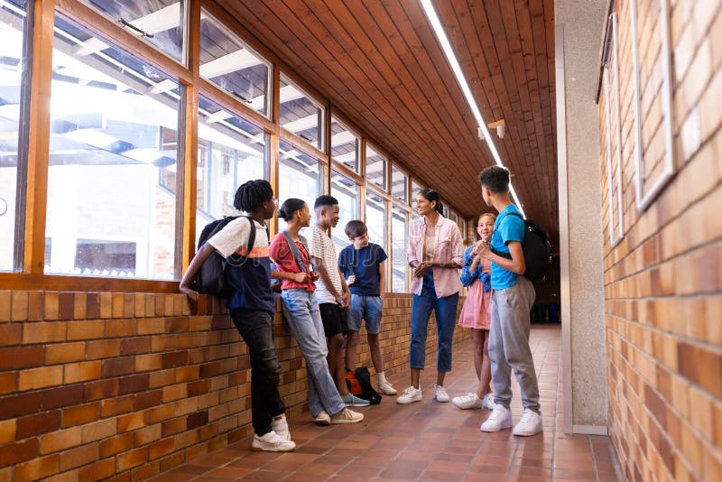 In School Hallway, Indian Female Teacher Talking with Group of Students ...
