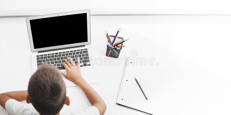 A School at Home through Online Homeschooling. the Child is Sitting at ...