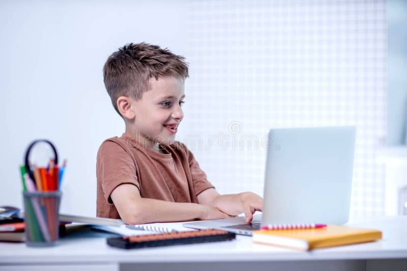 School Kid with Computer Having Video Conference Chat with Teacher and ...