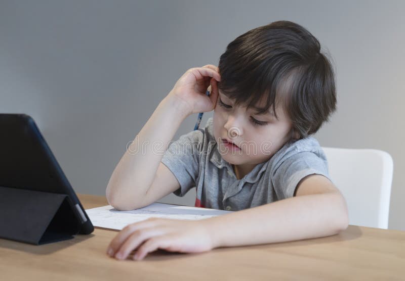School Kid in Self Isolation Using Tablet for Homework,Bored Child Sad ...