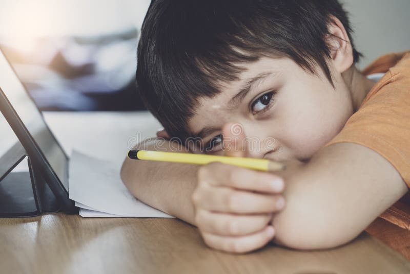 School Kid In Self Isolation Using Tablet For Homework,Child Sad Face ...