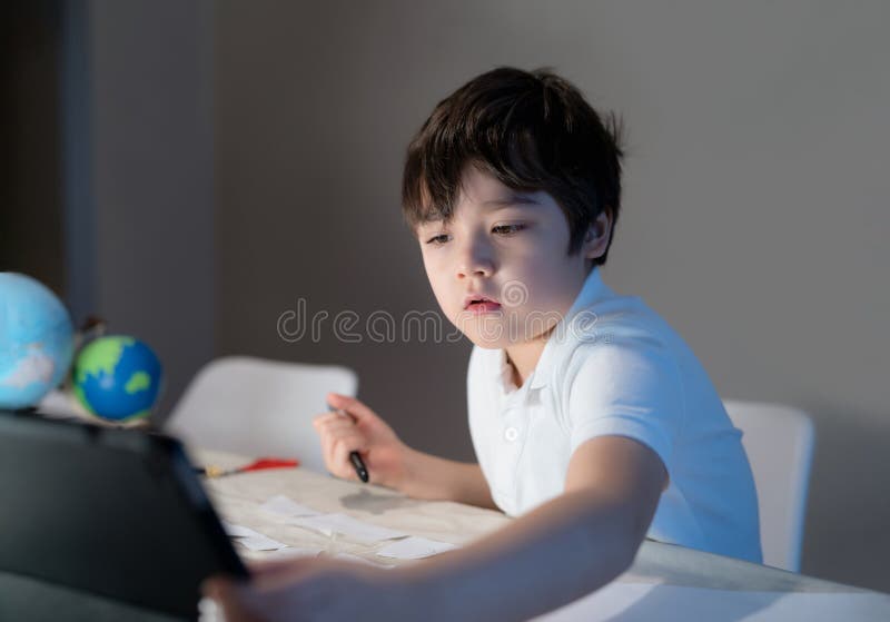 School Kid Using Tablet for His Homework,Child Boy Doing Homework by ...