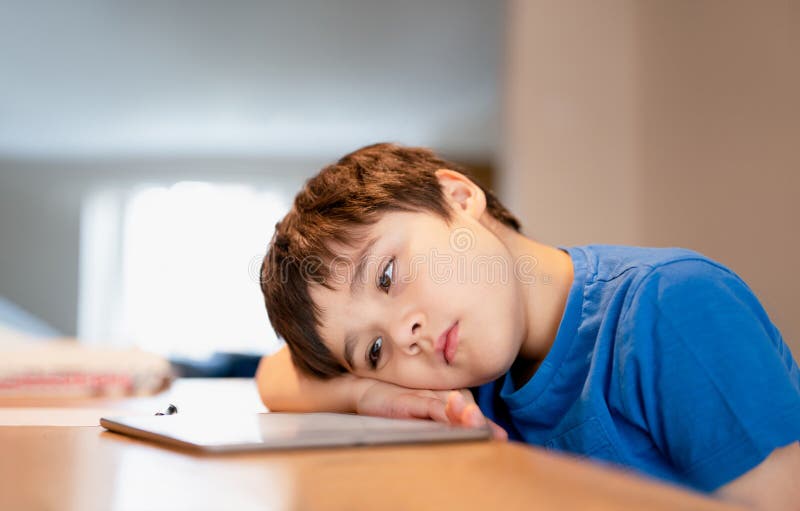 School Kid Using Tablet for Homework, Child Bored Face Lying Head Down ...