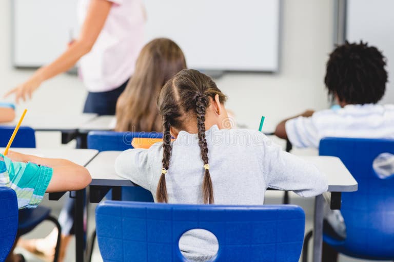 School Kids Doing Homework in Classroom Stock Photo - Image of class ...