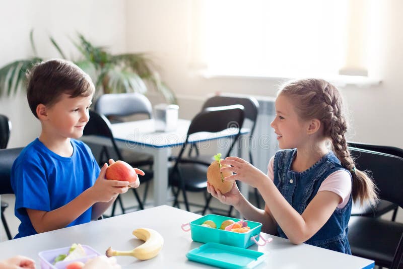 School Kids Eating Healthy Food Together. Happy Children Sitting at ... School Kids Eating Healthy Food Together. Happy Children Sitting at ...