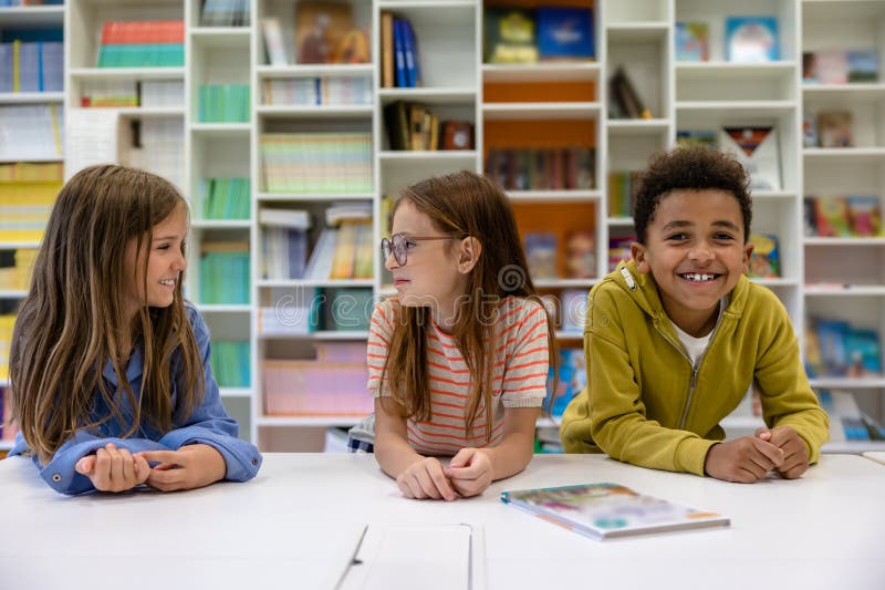 School Kids Sitting at Desk in School Library. Stock Photo - Image of ...