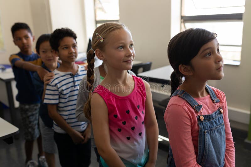 School Kids Standing in Row in Classroom of Elementary School Stock ...
