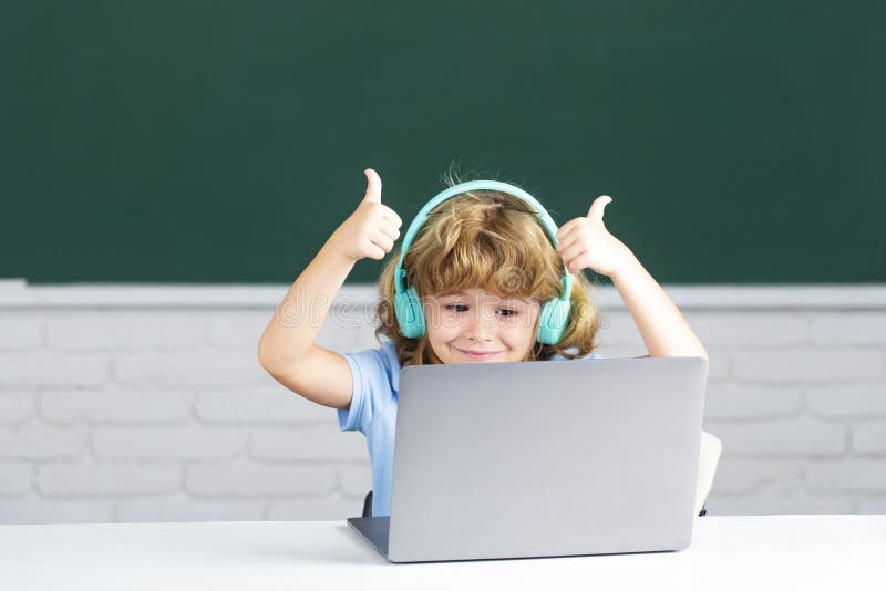 School Kids with Thumbs Up Using Laptop Computer and Headphones in ...