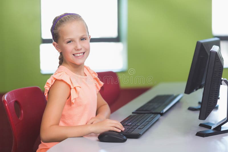 Elementary School Girl Typing on Keyboard and Moving Mouse in Computer ...
