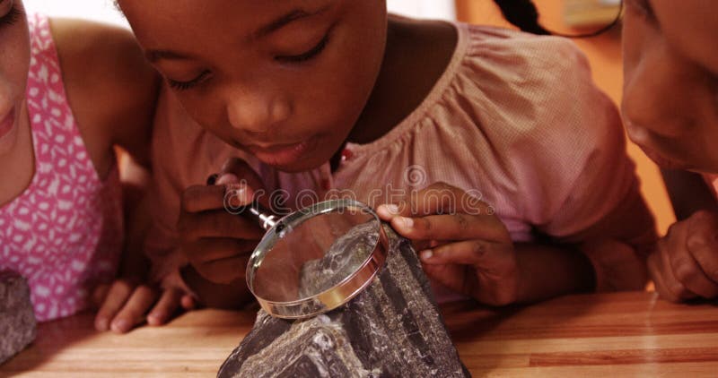 School Kids Using Magnifying Glass Over Rock Stock Video - Video of ...
