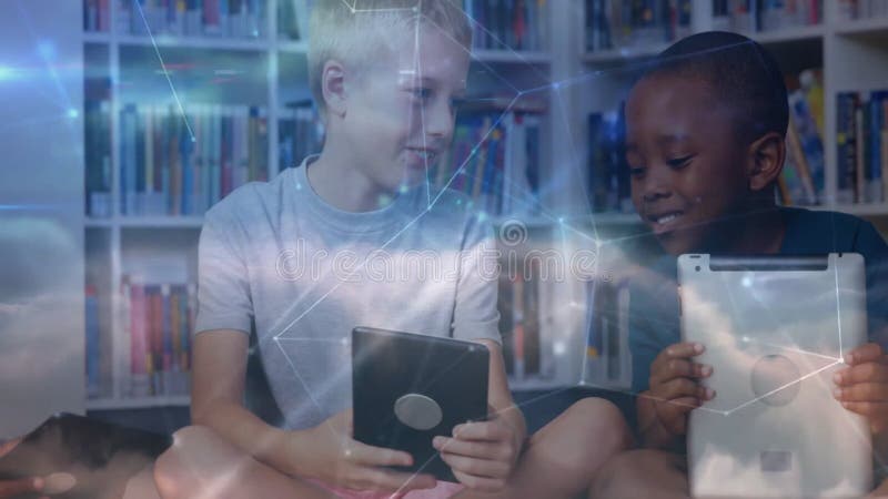 In School Library, Children Using Tablets with Digital Network Animation Overlay Stock Footage ...