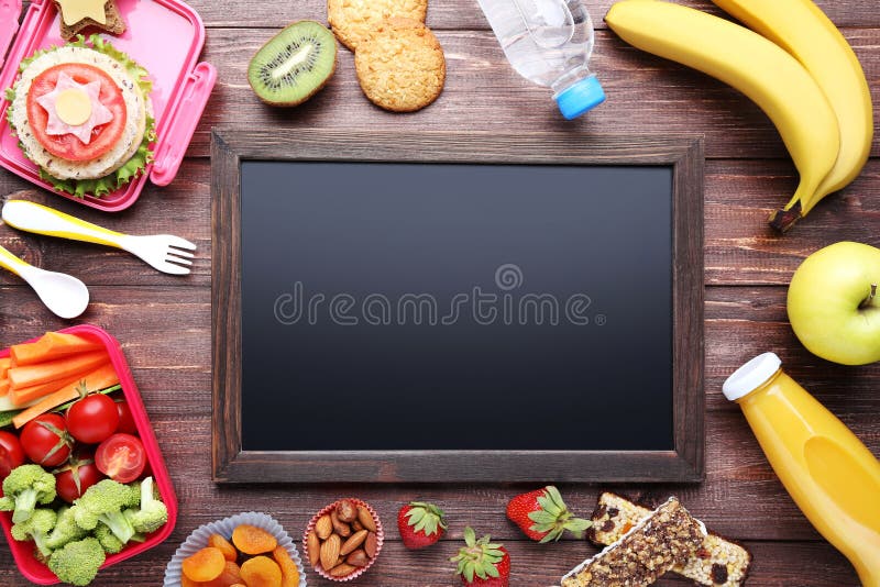 School Lunch Box with Sandwich, Vegetables, Water, and Fruits on Table ...