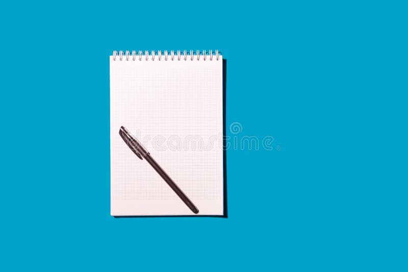 School Notebook in a Cage for Notes with a Ballpoint Pen on a Blue ...