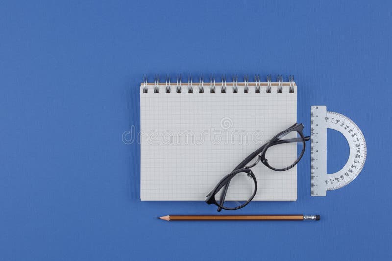 School Notebook with Pen and Glasses on Blue Table Stock Photo - Image ...