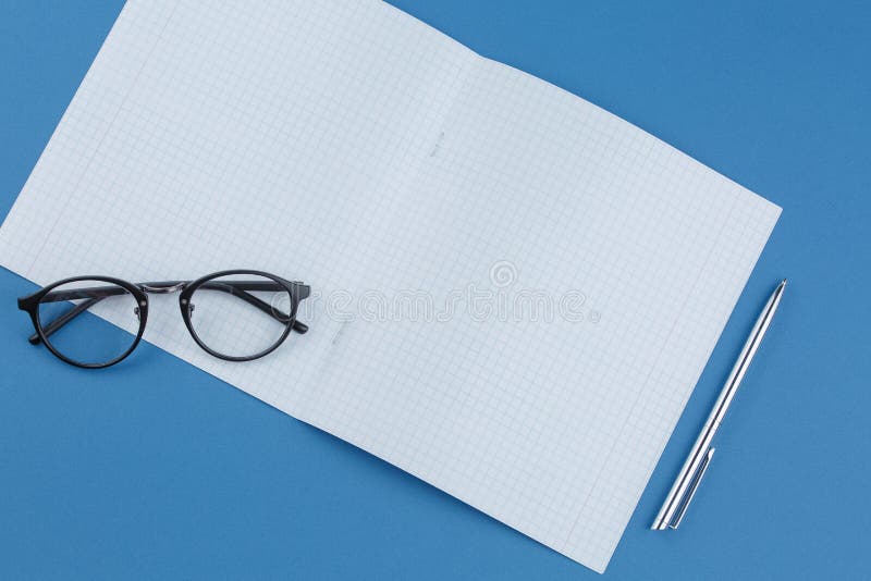 School Notebook with Pen and Glasses on Blue Table Stock Photo - Image ...