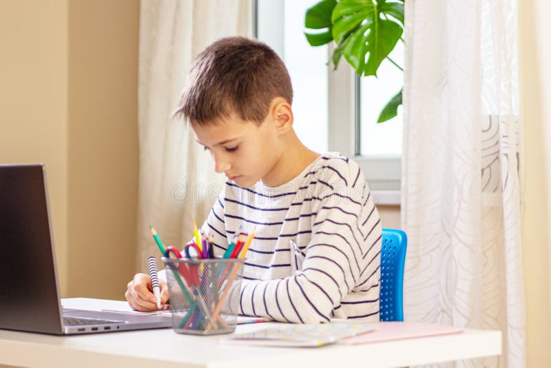 School Pupil with Laptop Computer Writing Notebook Doing Homework at ...