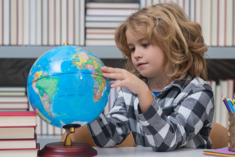 School Pupil Looking at Globe in Library, Geography Lesson. School ...