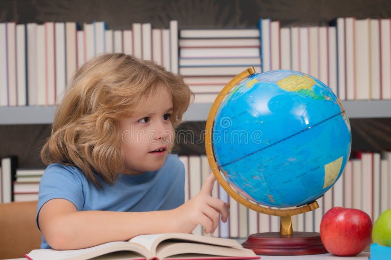 School Pupil Looking at Globe in Library, Geography Lesson. School ...