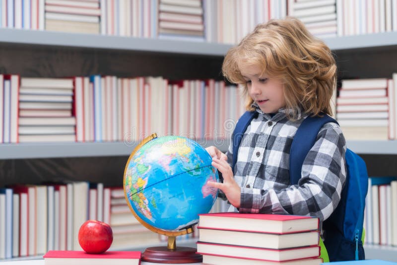 School Pupil Looking at Globe in Library, Geography Lesson. School ...