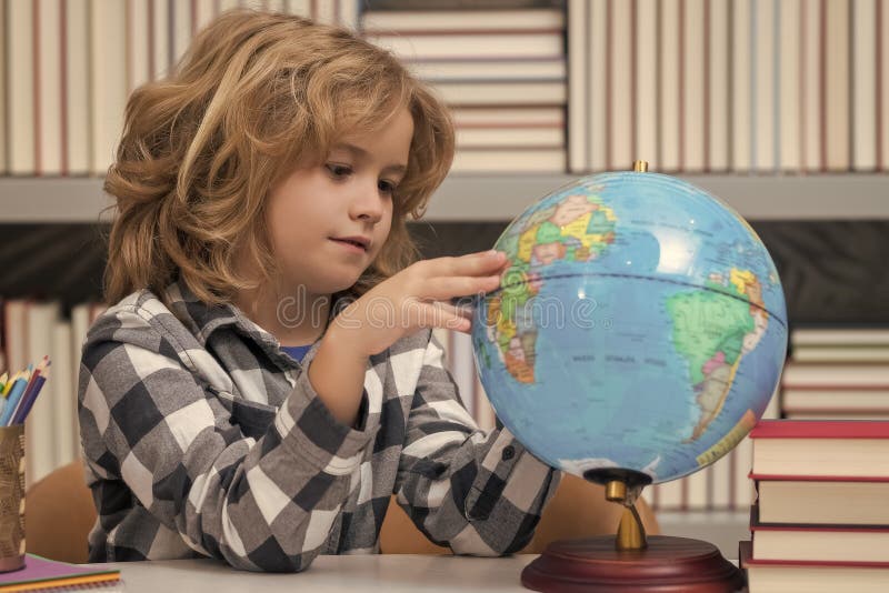 School Pupil Looking at Globe in Library, Geography Lesson. School ...