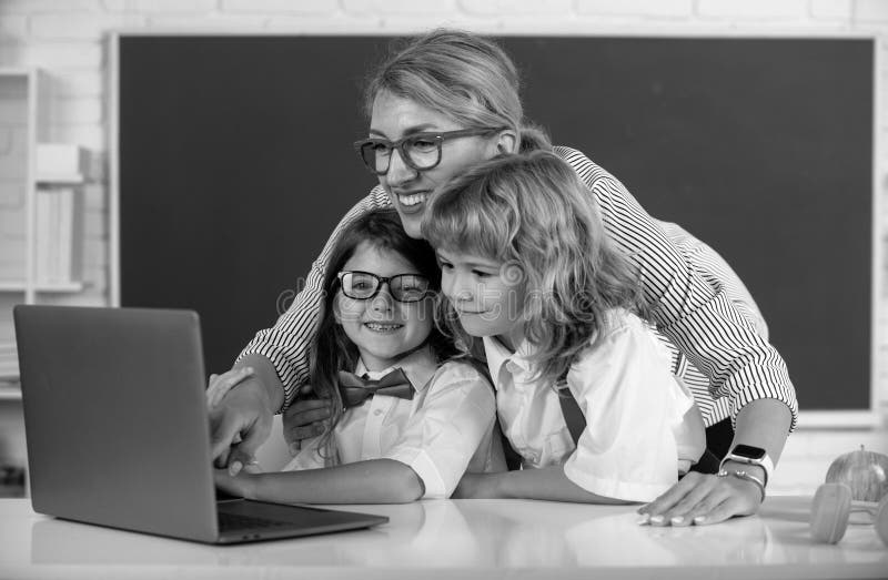 School Pupil with Teacher Learning at Laptop Computer, Studying with ...